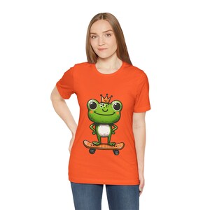 Unisex T-shirt With Cute Cartoon Frog Wearing a Crown on a Skateboard ...