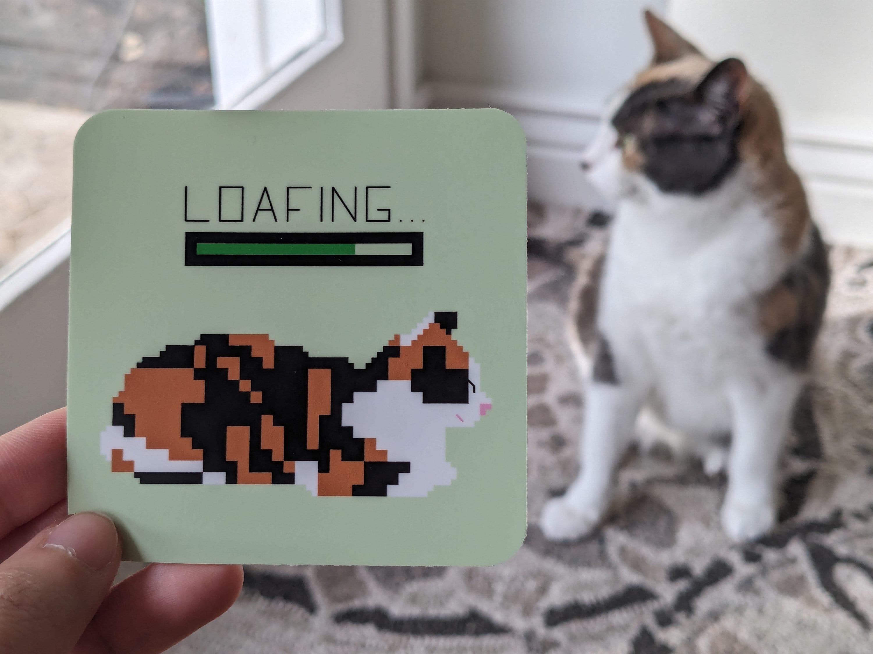 Cat Loaf Sticker: Pixel Art of a Calico Cat Under a Loading Bar on a ...