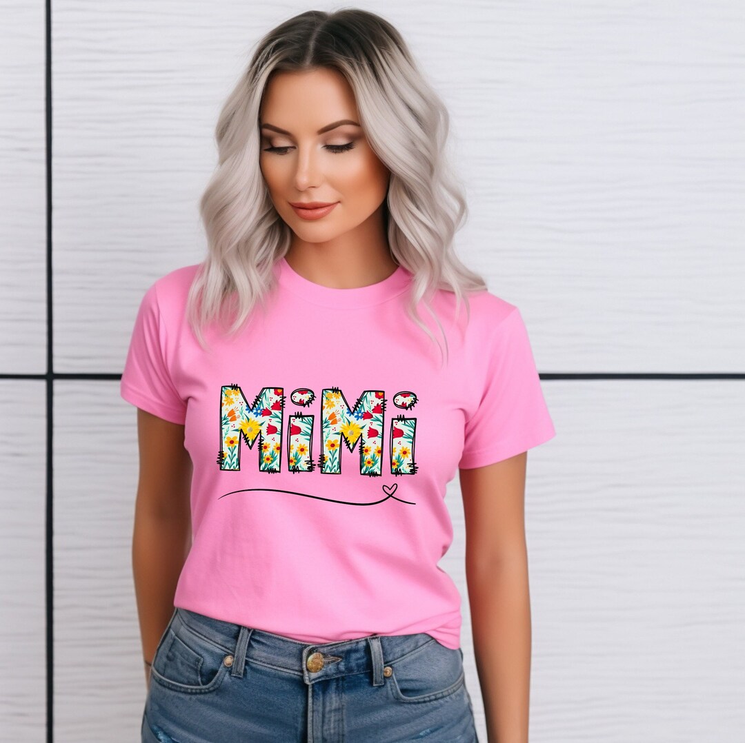 Floral Harmony: Mimi Logo Blossoms in a Garden of Letters on a Chic Tee ...