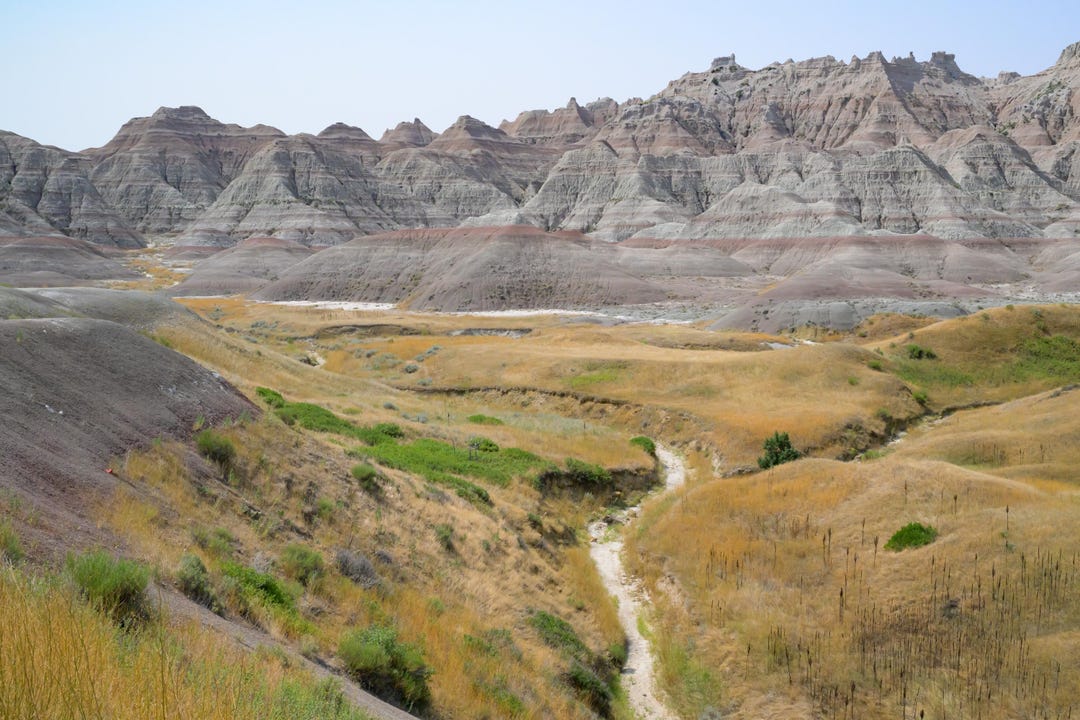 Dramatic Badlands Landscape With Grassland and Grey Red Striped Hills ...