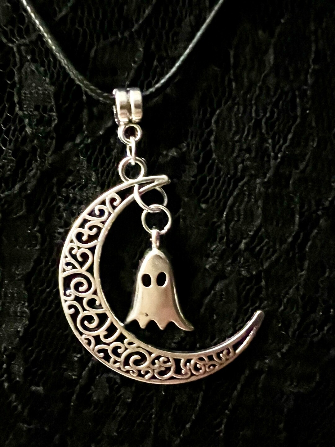 Paranormal Jewelry of A Ghost Charm Hanging Inside a Filigree Crescent ...