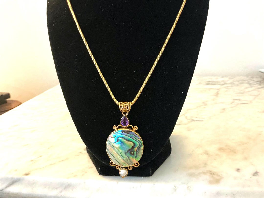 A Karis Necklace Featuring a Gold-tone Chain With an Amethyst, Abolone ...