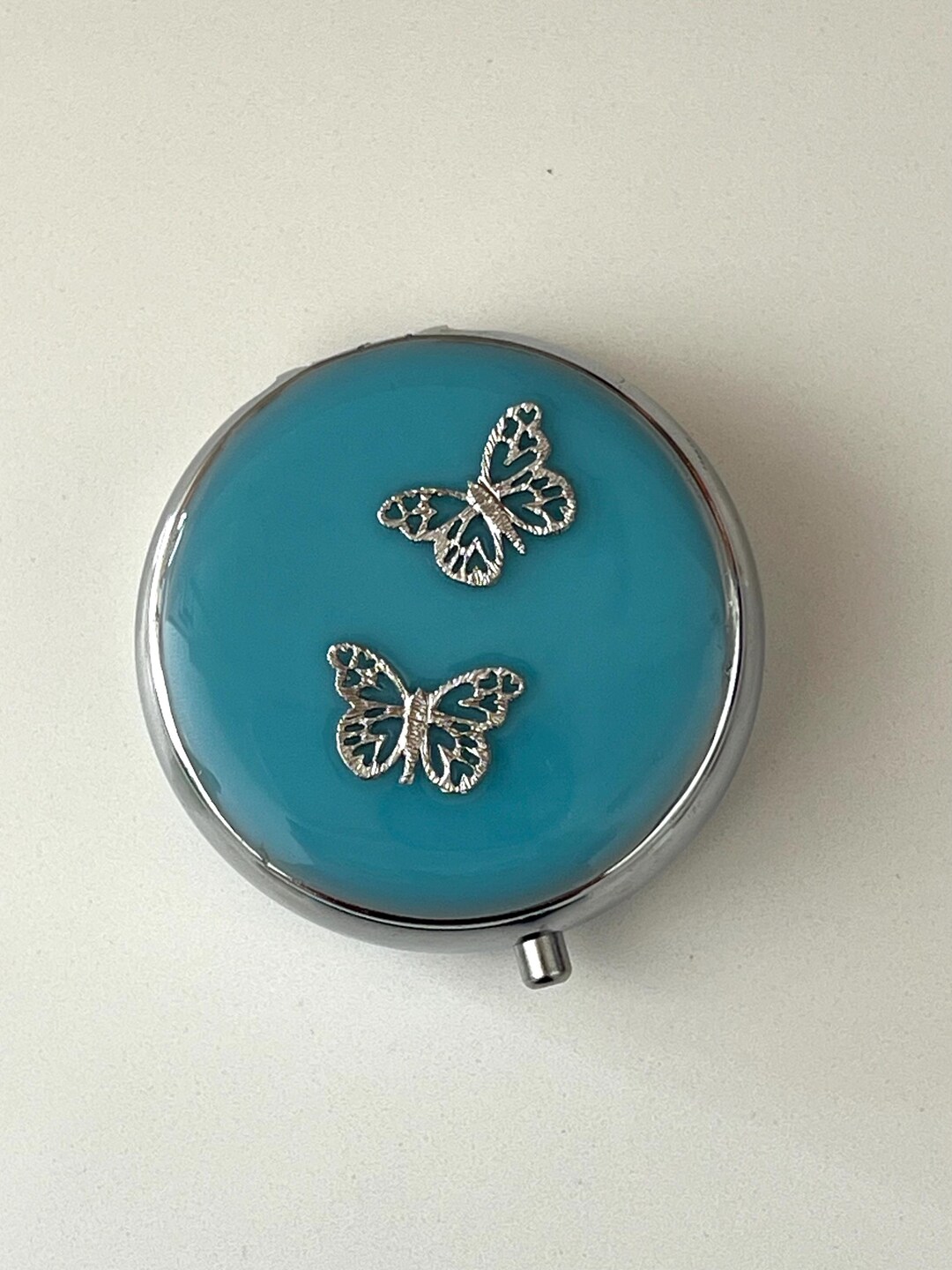 Pill Box With Two Silver Butterflies Set on a Glossy Blue Resin ...