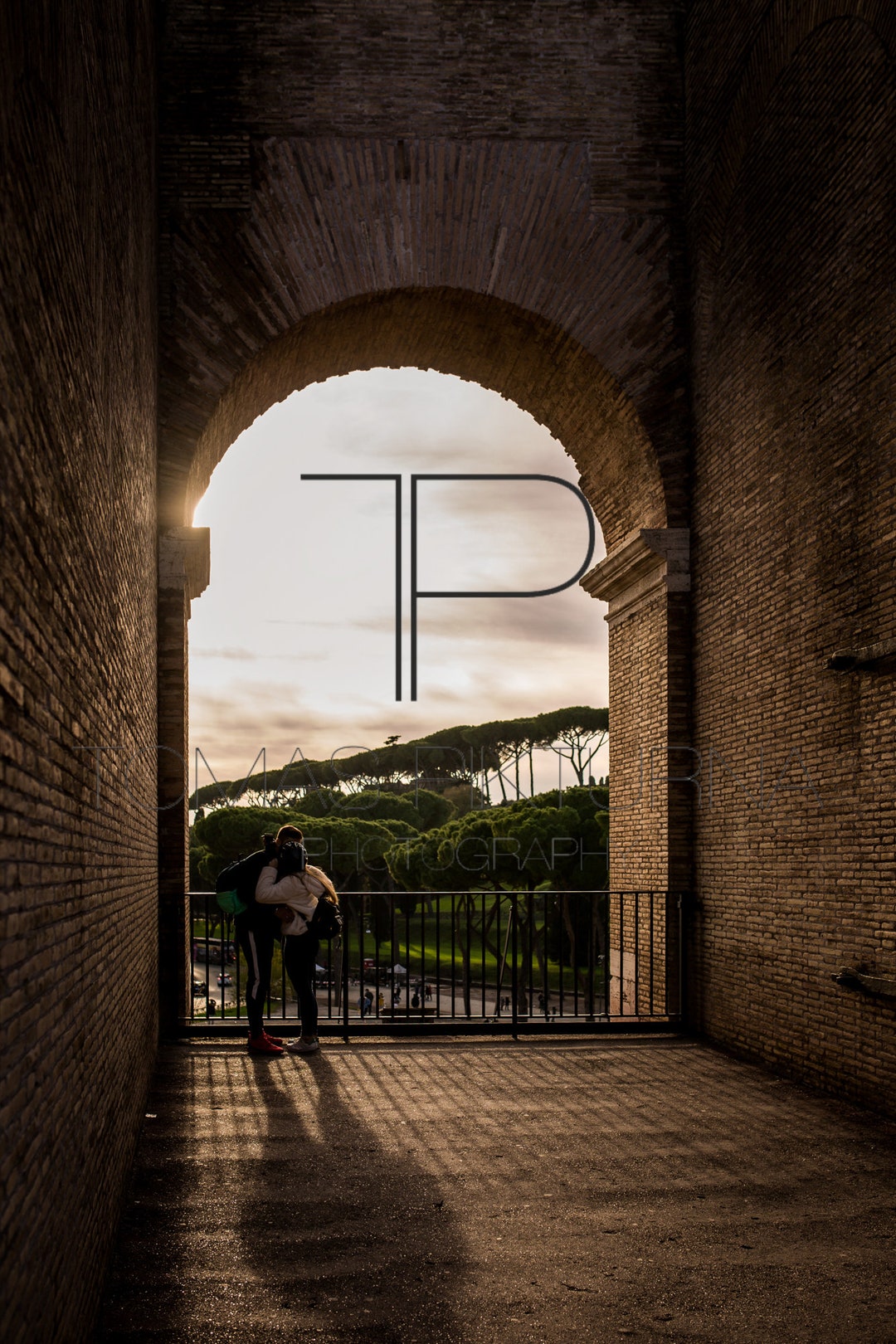 A Couple in Love in the Arch of the Roman Coliseum at Sunset. Italy's ...