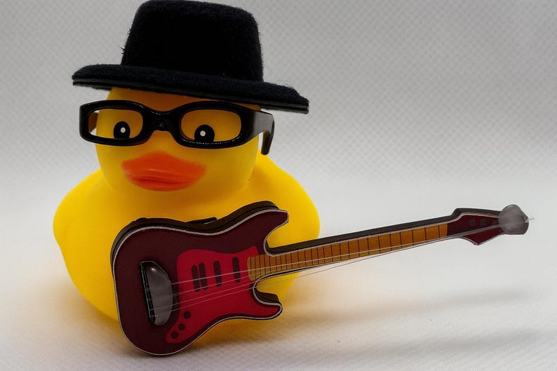 A Rubber Duck Playing a Musical Instrument of Your Choice, Adorned With ...