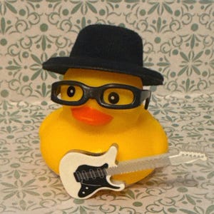 A Rubber Duck Playing a Musical Instrument of Your Choice, Adorned With ...
