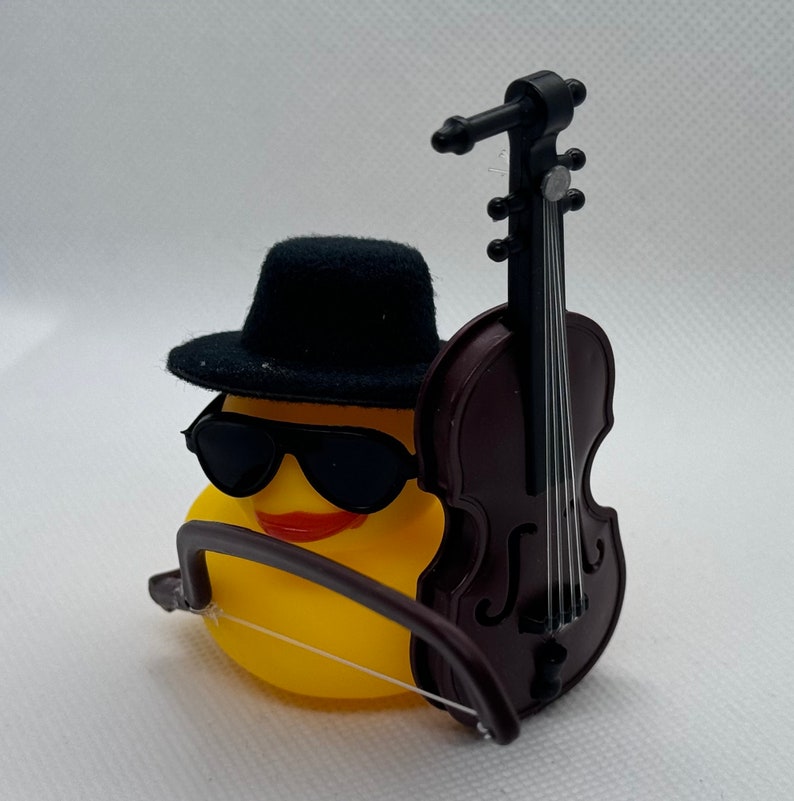 A Rubber Duck Playing a Musical Instrument of Your Choice, Adorned With ...
