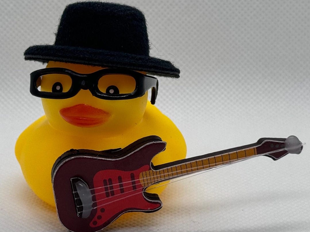 A Rubber Duck Playing a Musical Instrument of Your Choice, Adorned With ...