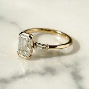 14kt Gold With 3ct Emerald & Tapper Baguette Moissanite Three Stone ...