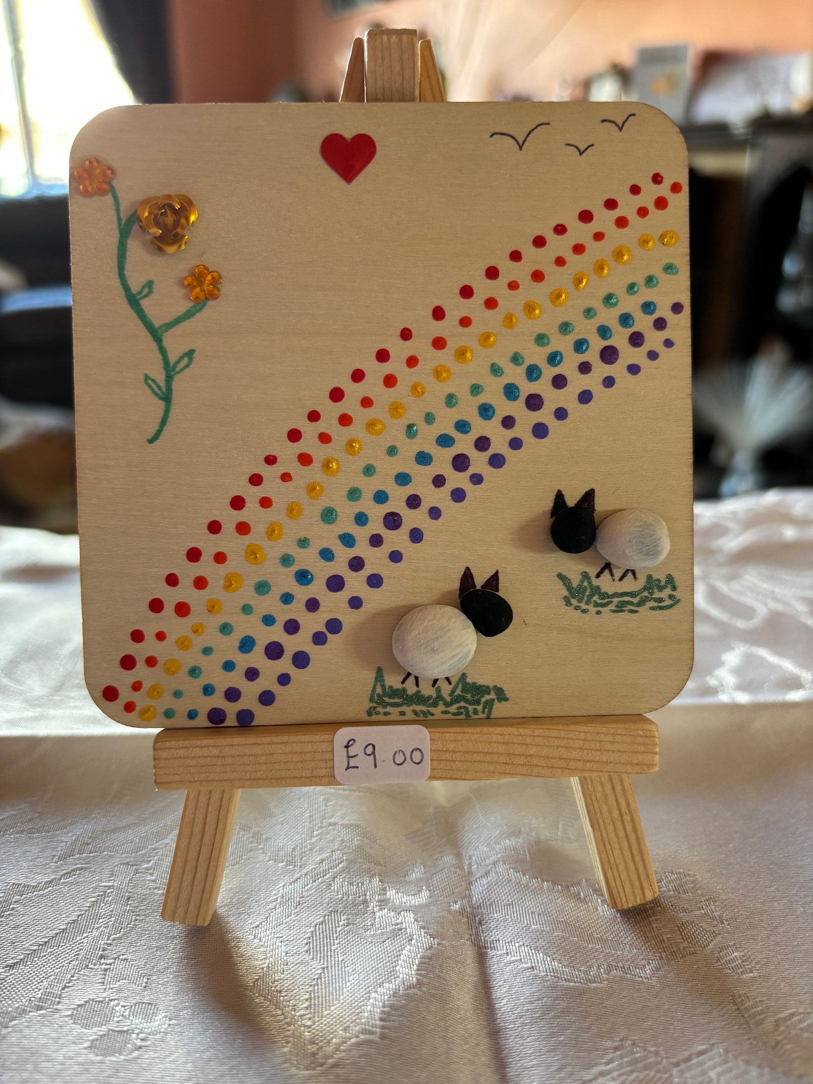 A Rainbow, Pebble Sheep and Yellow Gem Flowers Set on a Mini Easel ...