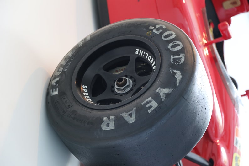 Front Wheel of Wall Mounted Red Ferrari 1990 641 F1 Car in a Business ...