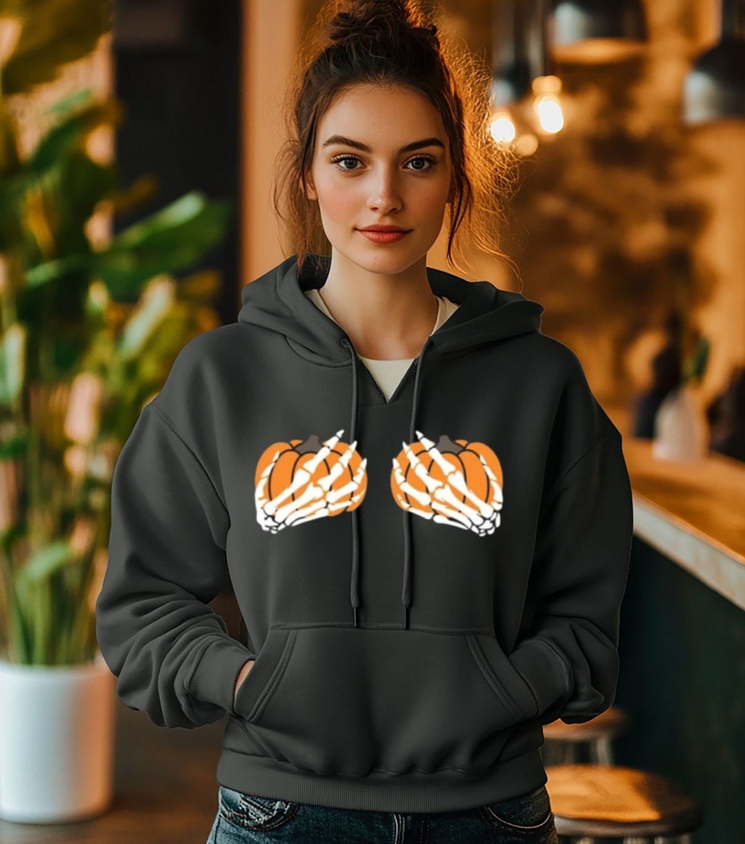 Fun and Spooky Skeleton Hand Holding Pumpkins Hoodie Halloween Vibe ...