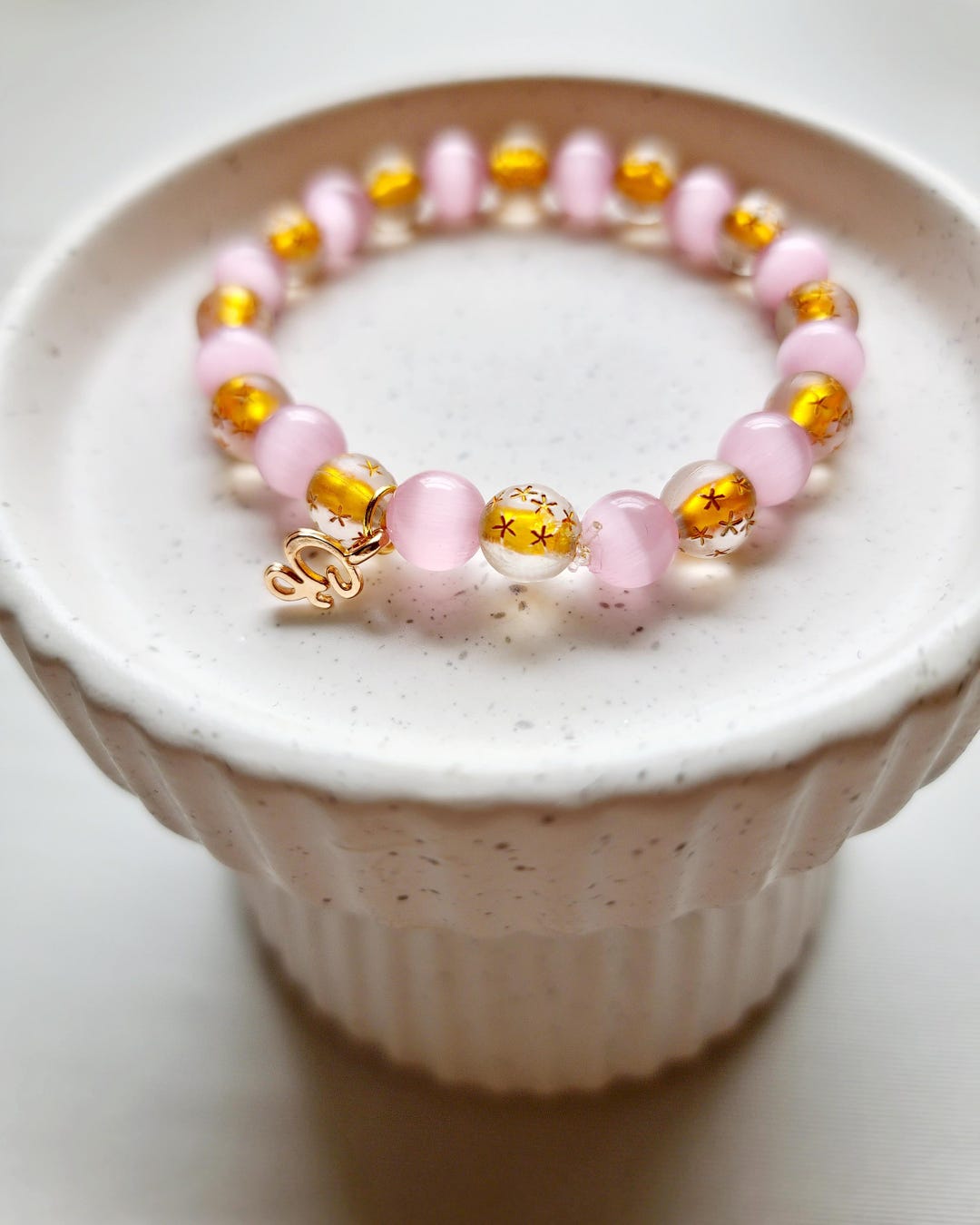 Toss Toss | Wicked-inspired Beaded Bracelet, Pink Cat Eye Glass Beads ...
