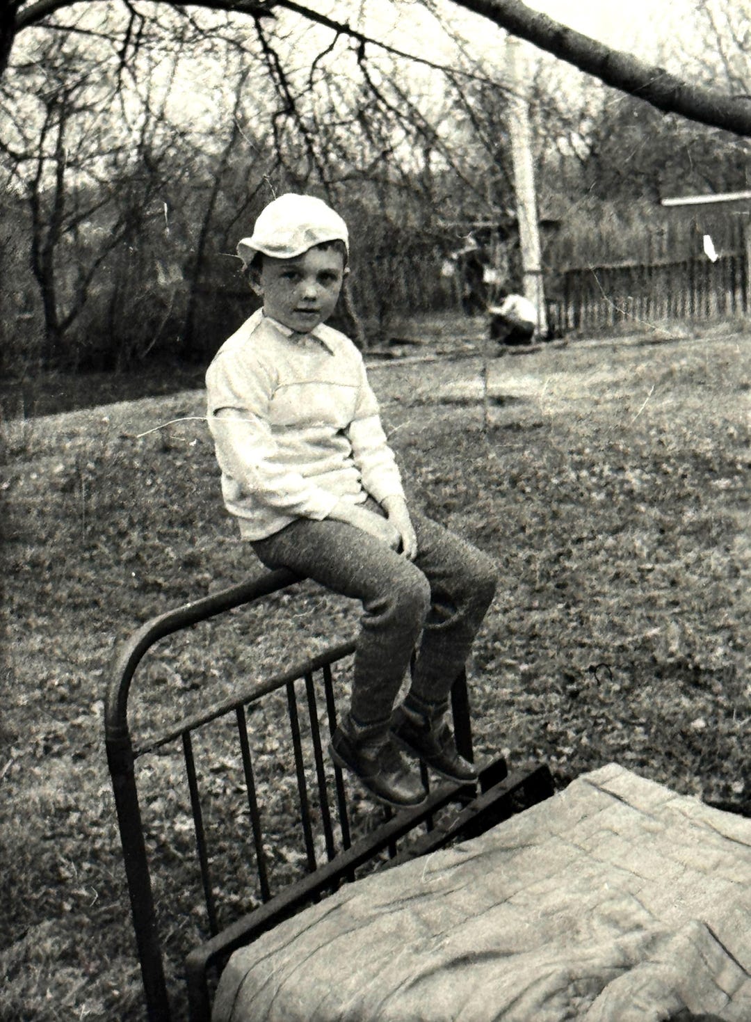 Vintage Photo 1970s Little Boy Sits on the Back of Iron Bed Black and ...