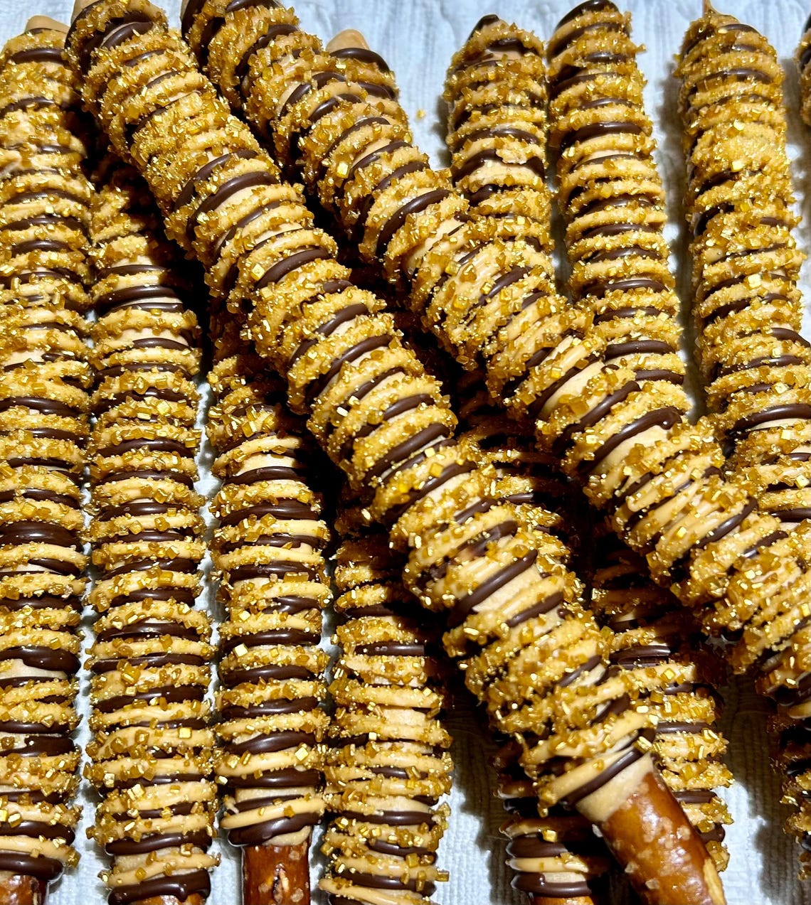 Caramel Coated Pretzel Rods With Chocolate Drizzle & Golden Sugar ...