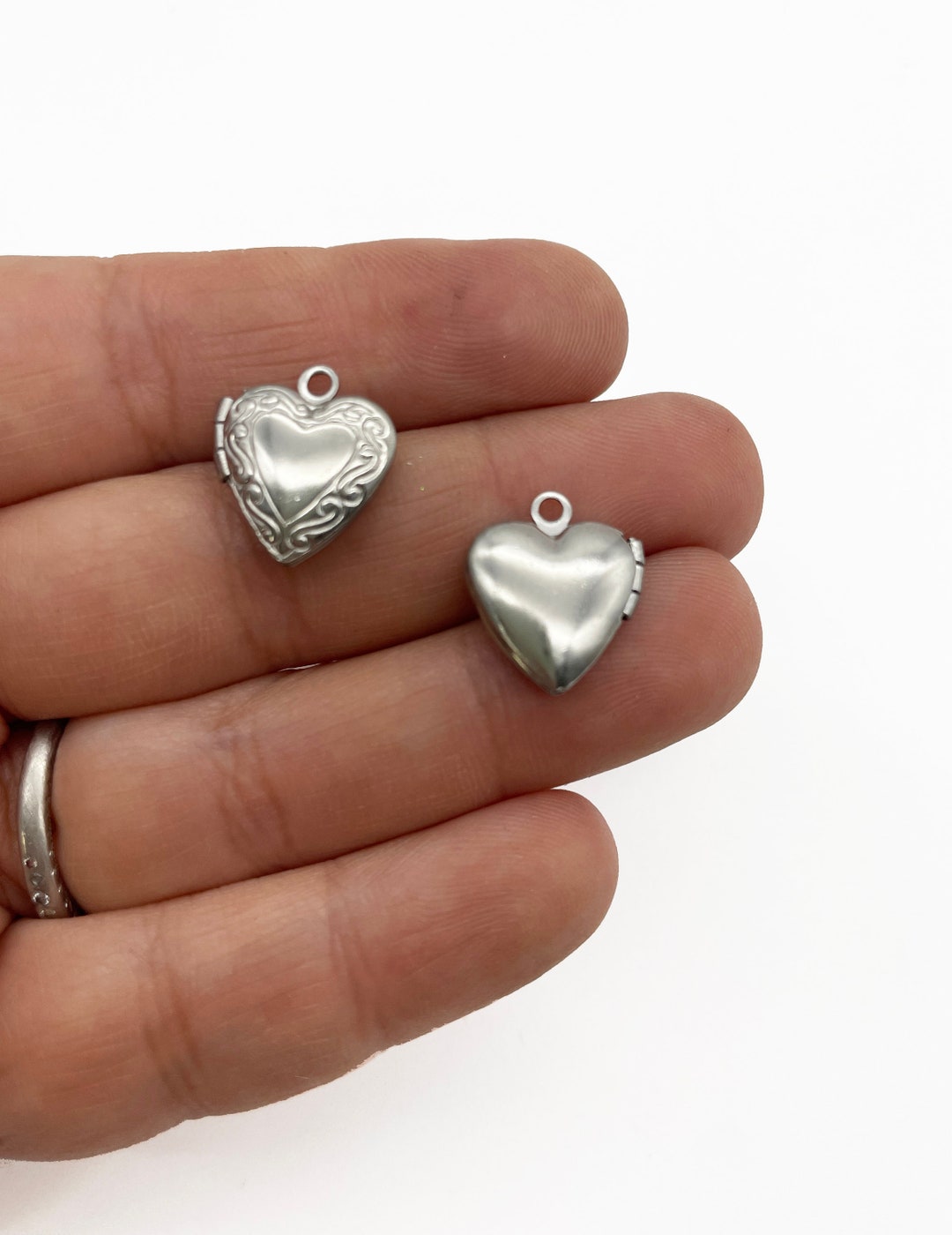 2 Small Stainless Steel Heart Lockets With Decorative Patterns on the ...