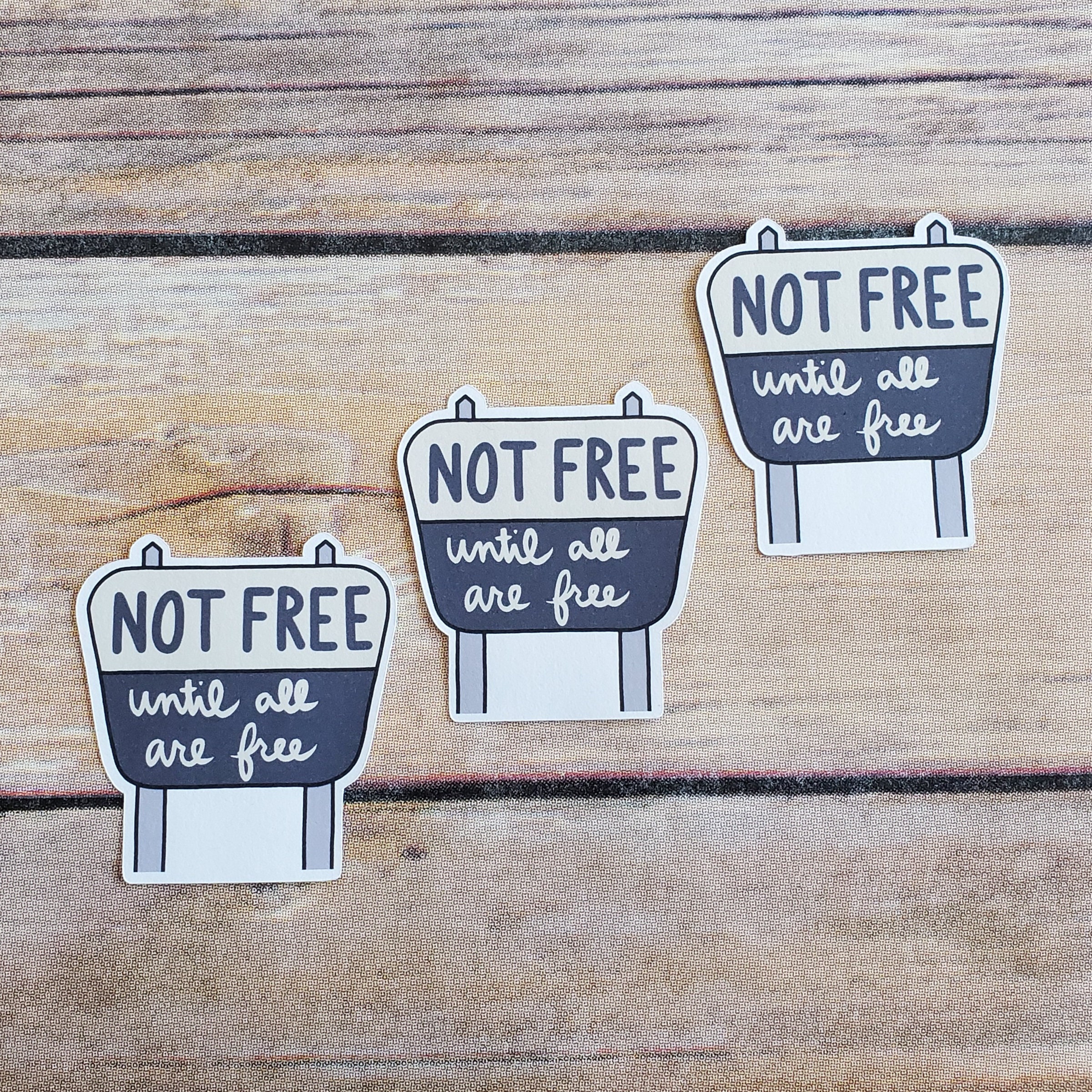 not free until all are free sign sticker — AnneArchy