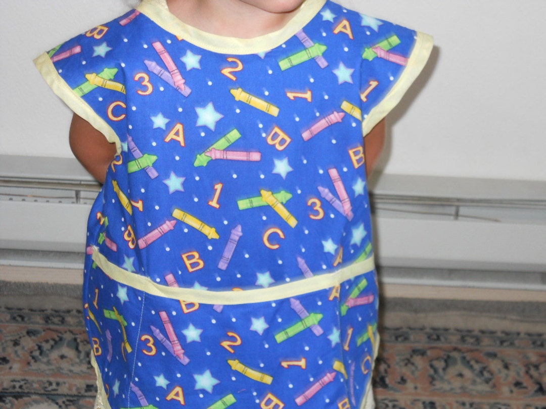 School Apron With Blue Background, Pencils, Rulers, Stars and Color ...