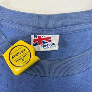 Vintage 1986 Reebok International Seal of Fashion Logo Graphic T-shirt ...
