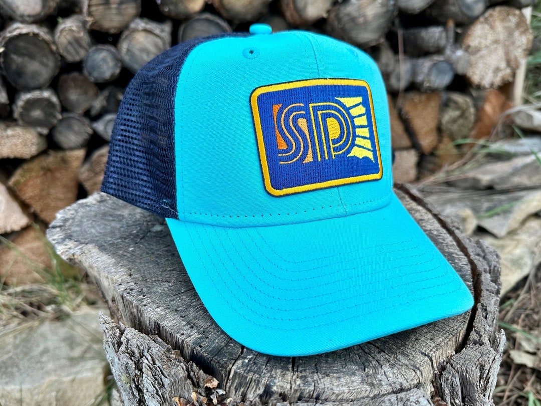 SD Sunny Caribbean Blue W/ Navy Trucker Hat - South Dakota Sunny Retro ...