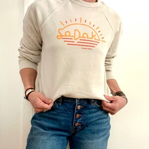 Sodak Neon Sun Crew Sweatshirt by Oh Geez! Design - South Dakota ...