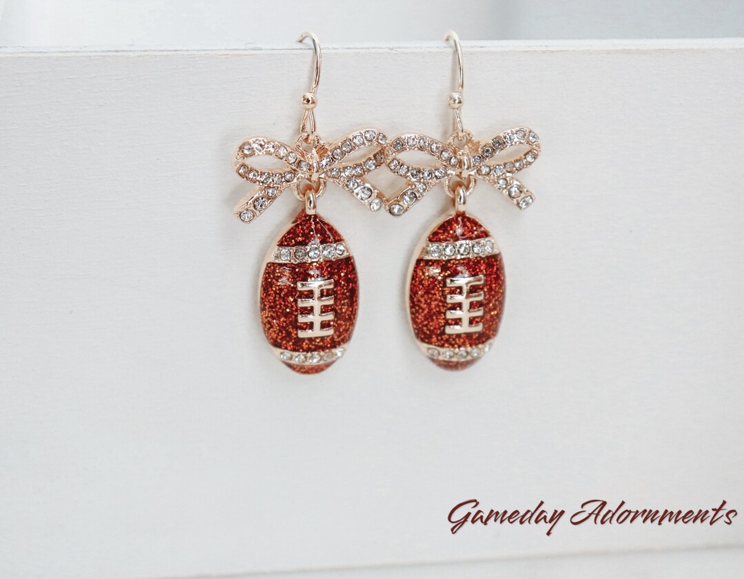 Glittery Football Enamel Hook Earrings With Rhinestones Bow Accent and ...