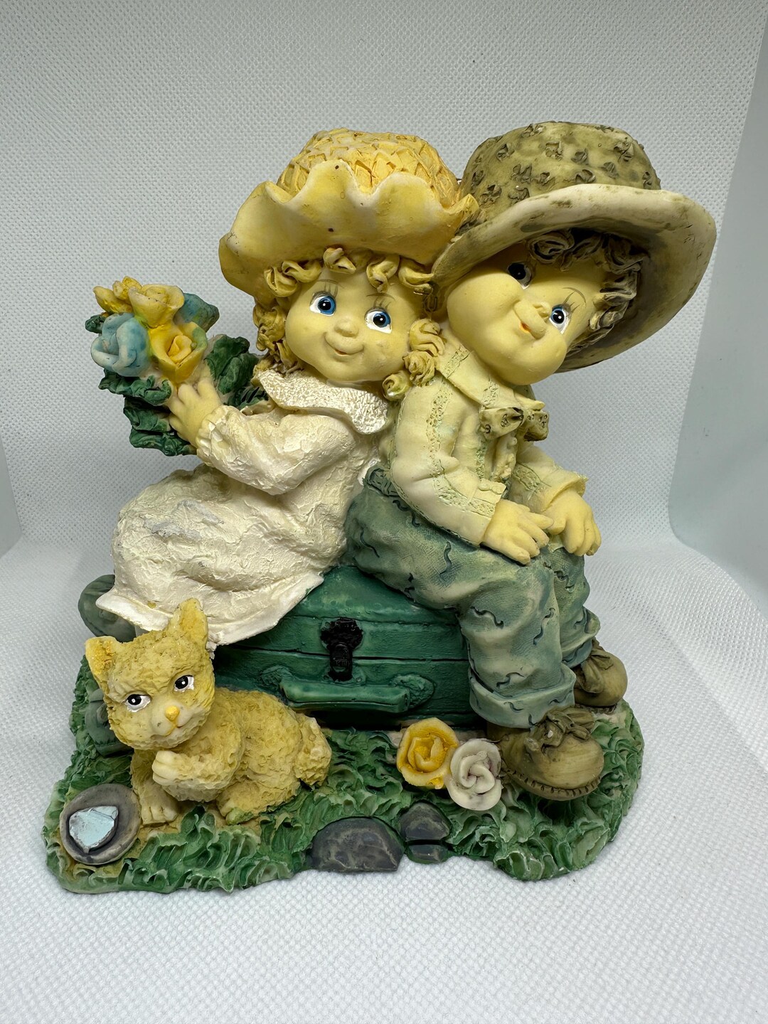 Charming Ceramic Figurine of Two Children Sitting Together on a Green ...