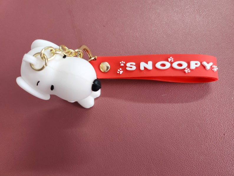 Charming Snoopy Keychain – White Snoopy Figure With Red Hand Strap and ...