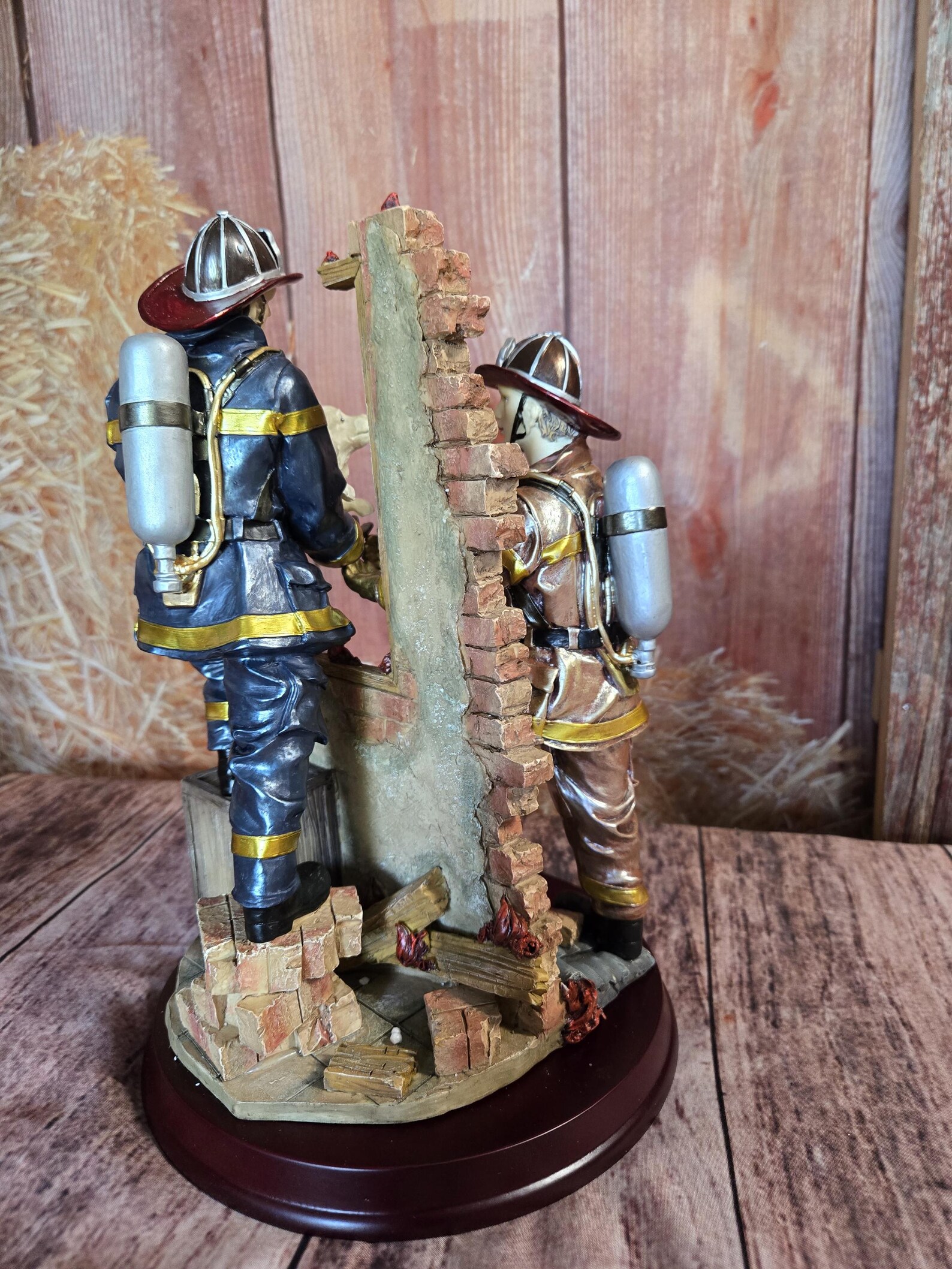 Statue of a Firefighter Handing a Puppy Out of a Burning Building to ...