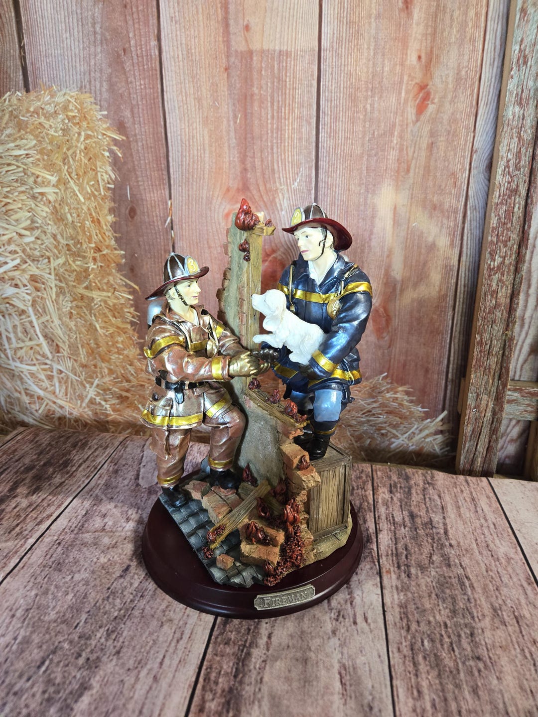 Statue of a Firefighter Handing a Puppy Out of a Burning Building to ...