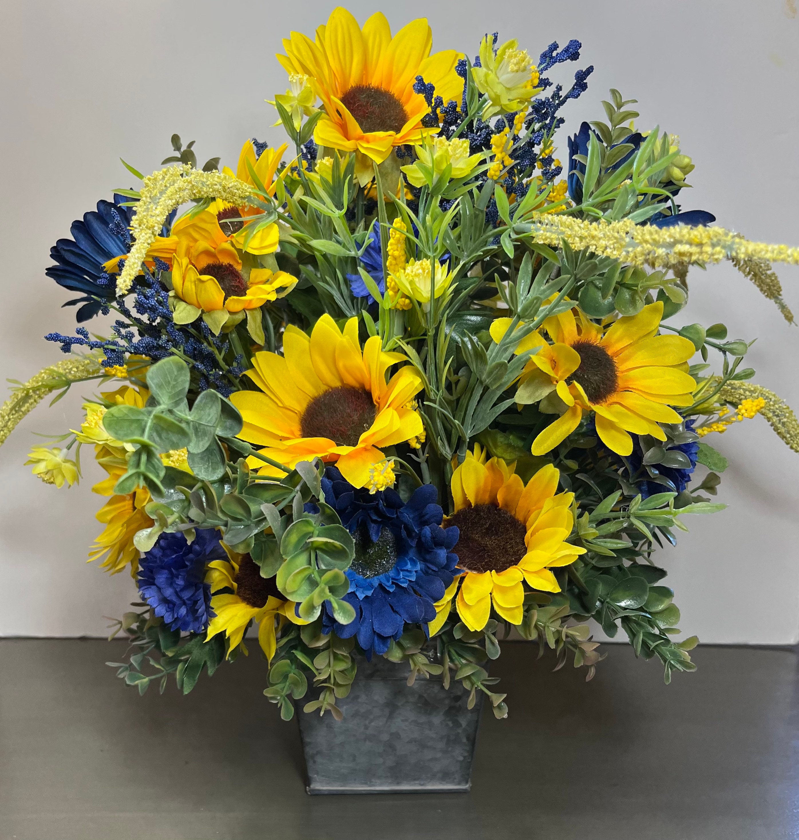 Blue Vase And Sunflower Centerpiece