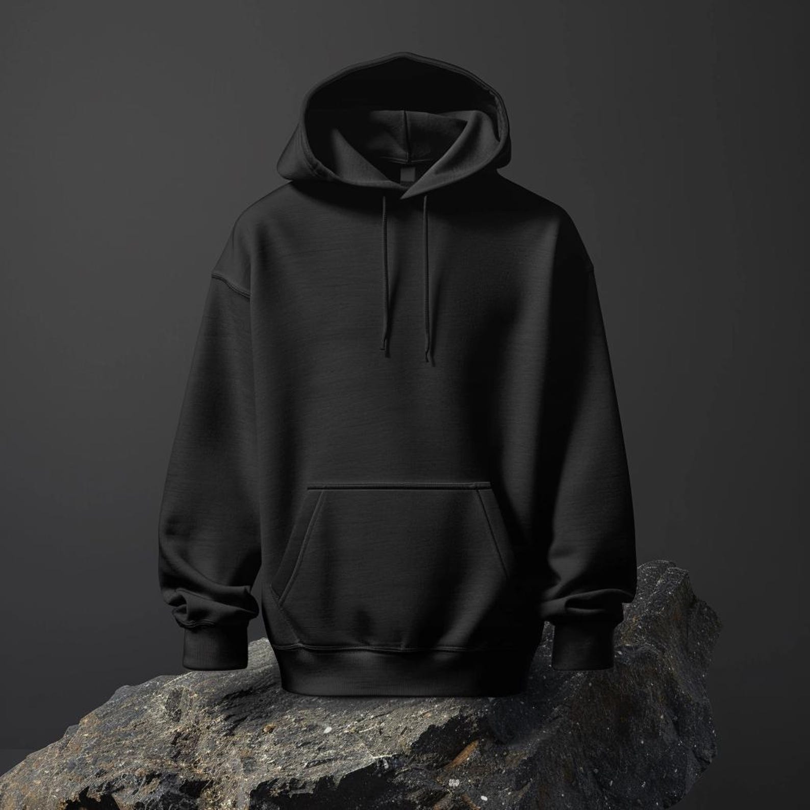 Mockup of Black Hoodie With Drawstrings on a Rock With a Plain Dark ...