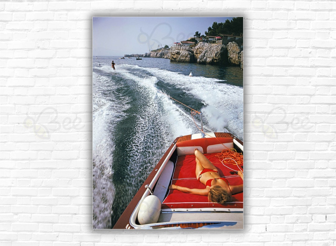 Slim Aarons Leisure in Antibes Print/poster - Woman Sunbathing in Boat Towing Waterskier Near ...