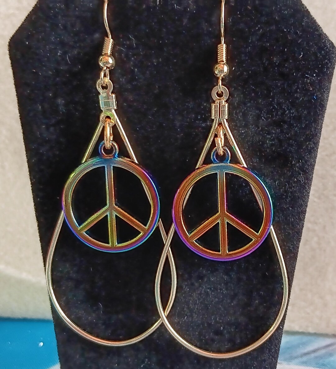 Gold, Tear Shape Drop With a Iridescent Peace Sign Hanging in the ...