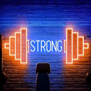 Awesome Motivational Neon Sign With Dumbbells and Strong Text in the ...
