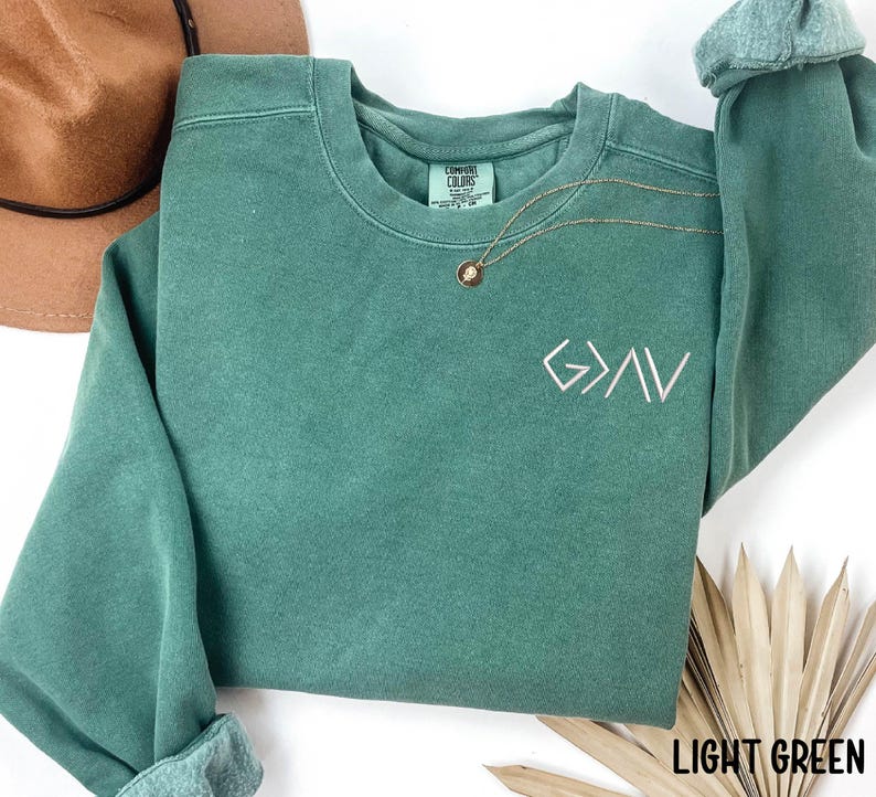 Embroidered God is Greater Than the Highs and Lows Pocket Sweatshirt ...