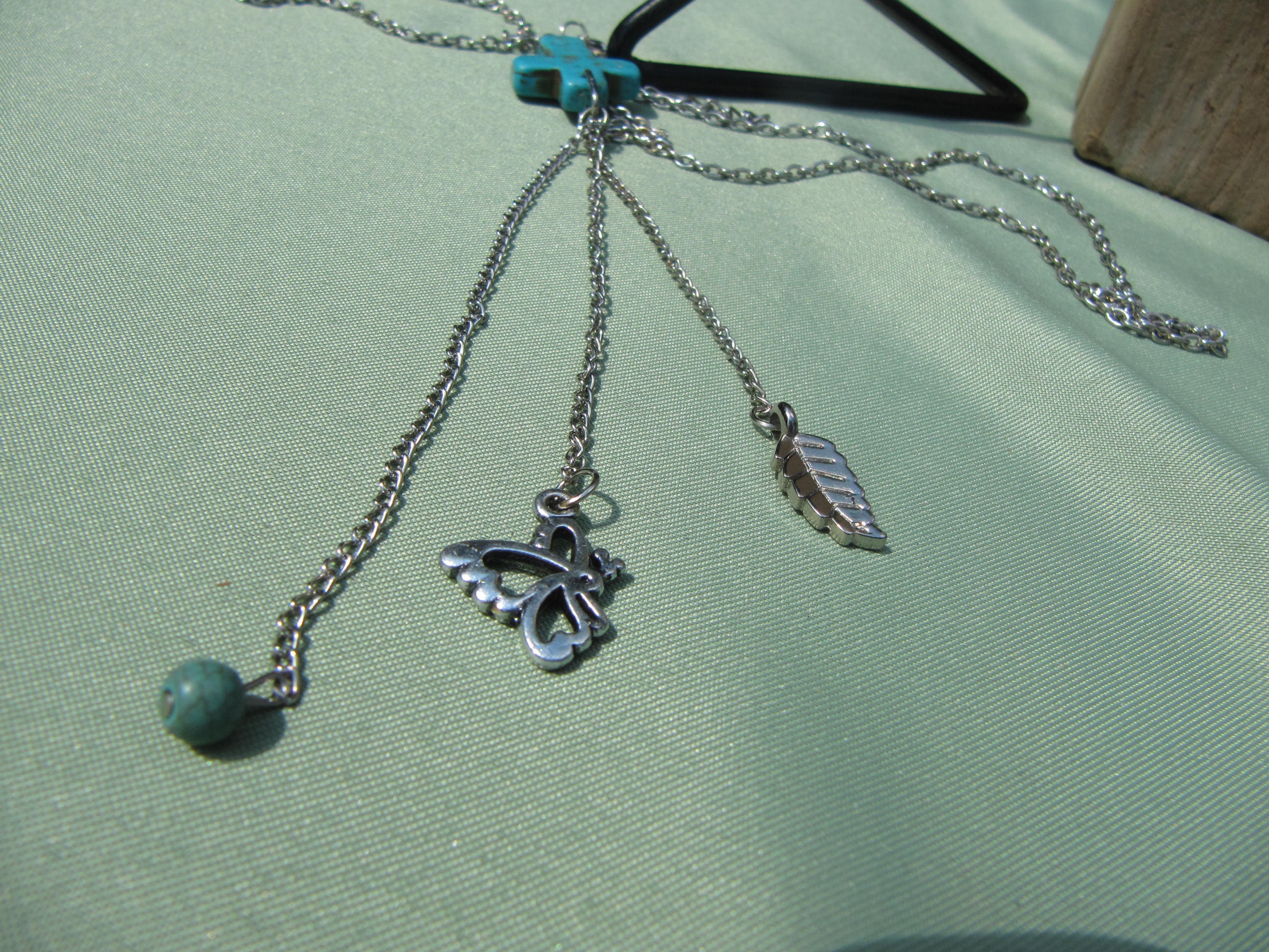 TURQUOISE CROSS and CHARMS on Silver Tone Chain, One in TURQUOISE CROSS and CHARMS on Silver Tone Chain, One in