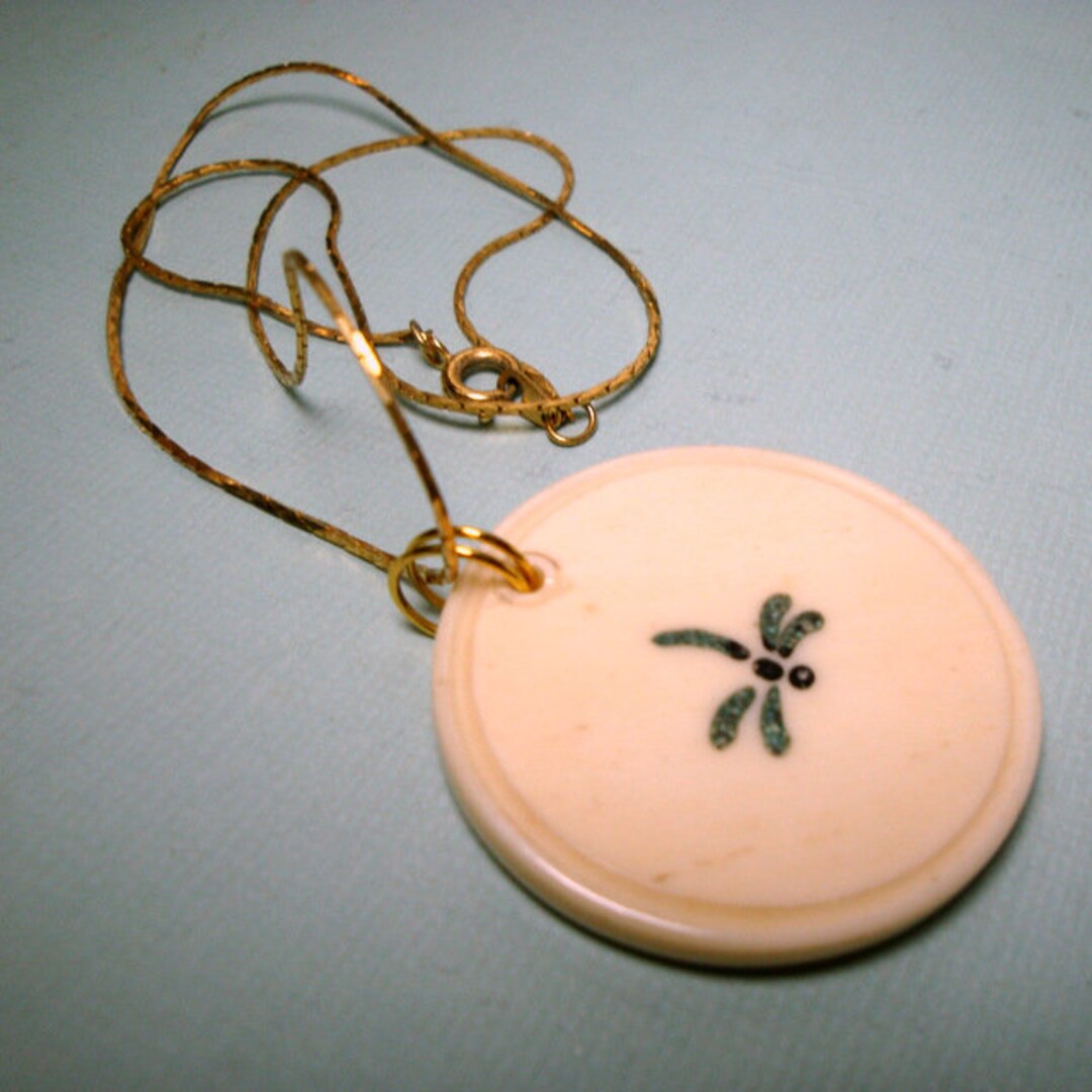 Oxbone Circle Pendant on Shiny Gold Chain, 1980s, Flowering Lily ...