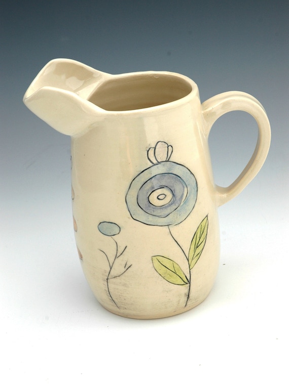 Handmade white pottery pitcher with flowers and unique design | Etsy