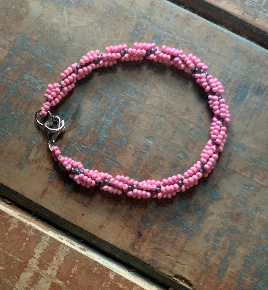 Handmade Twisted Beaded Rope Bracelet in Matt Pink With Gray Background ...