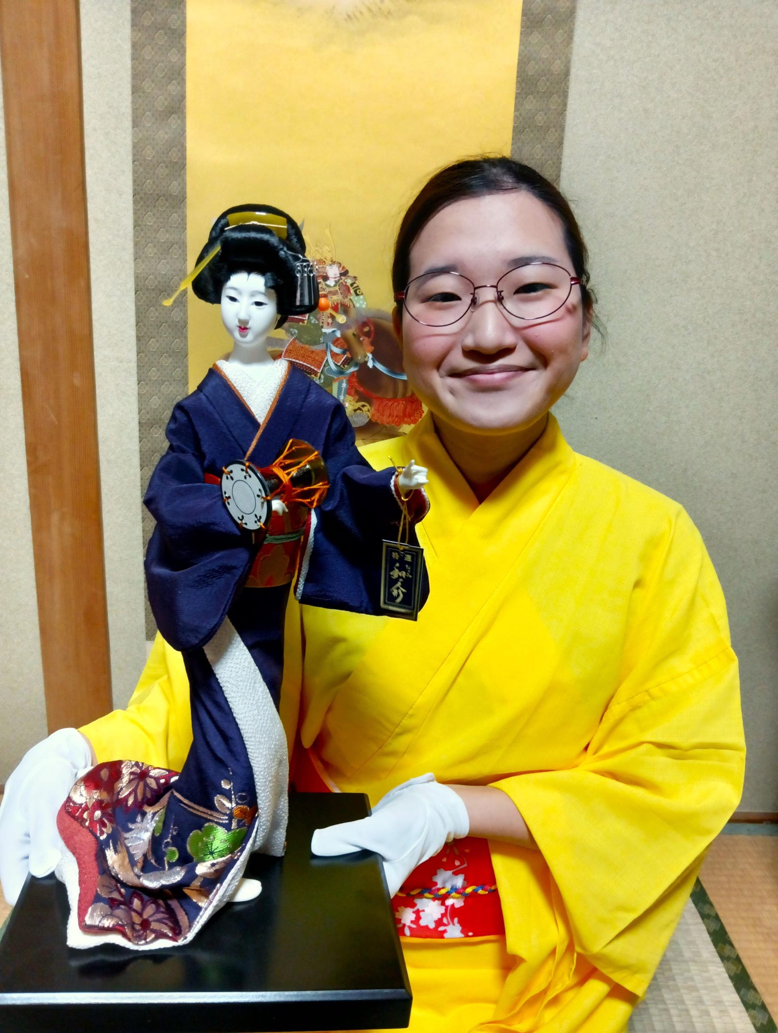 A Beautiful and Cute Geisha Doll. She is Wearing a Purple Kimono With ...