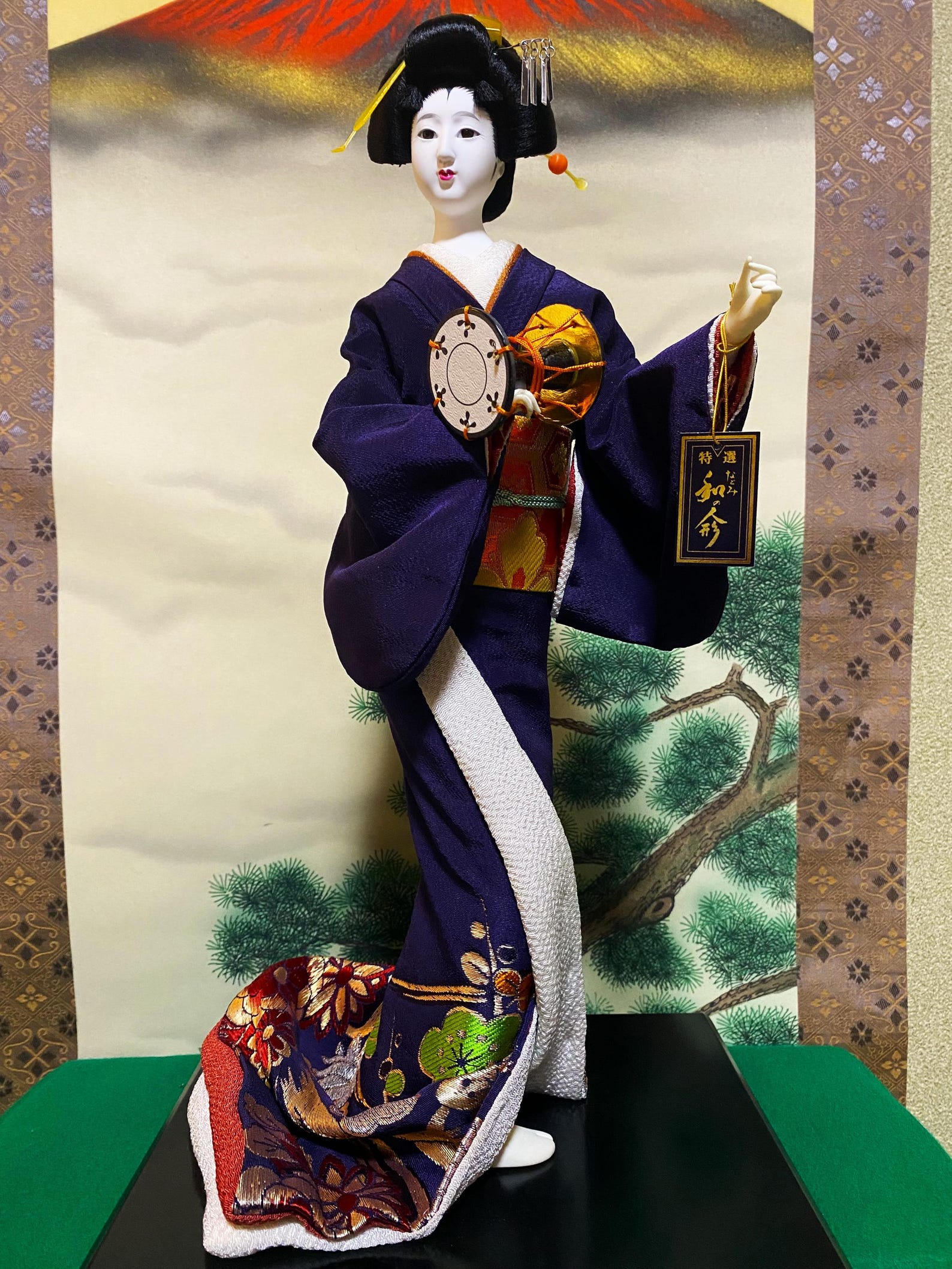 A Beautiful and Cute Geisha Doll. She is Wearing a Purple Kimono With ...