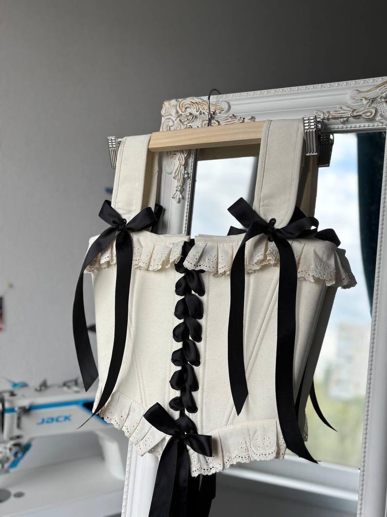 Vintage-inspired Corset With Delicate Lace Trim and Elegant Black Bows ...
