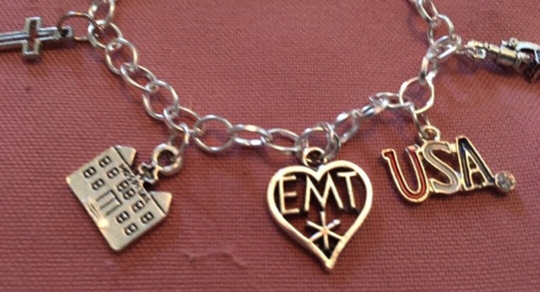 FREE SHIPPING Charm Bracelet EMT Nine Silver Charms Stainless Bracelet ...