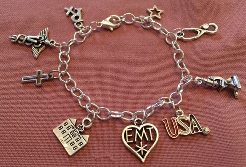 FREE SHIPPING Charm Bracelet EMT Nine Silver Charms Stainless Bracelet ...