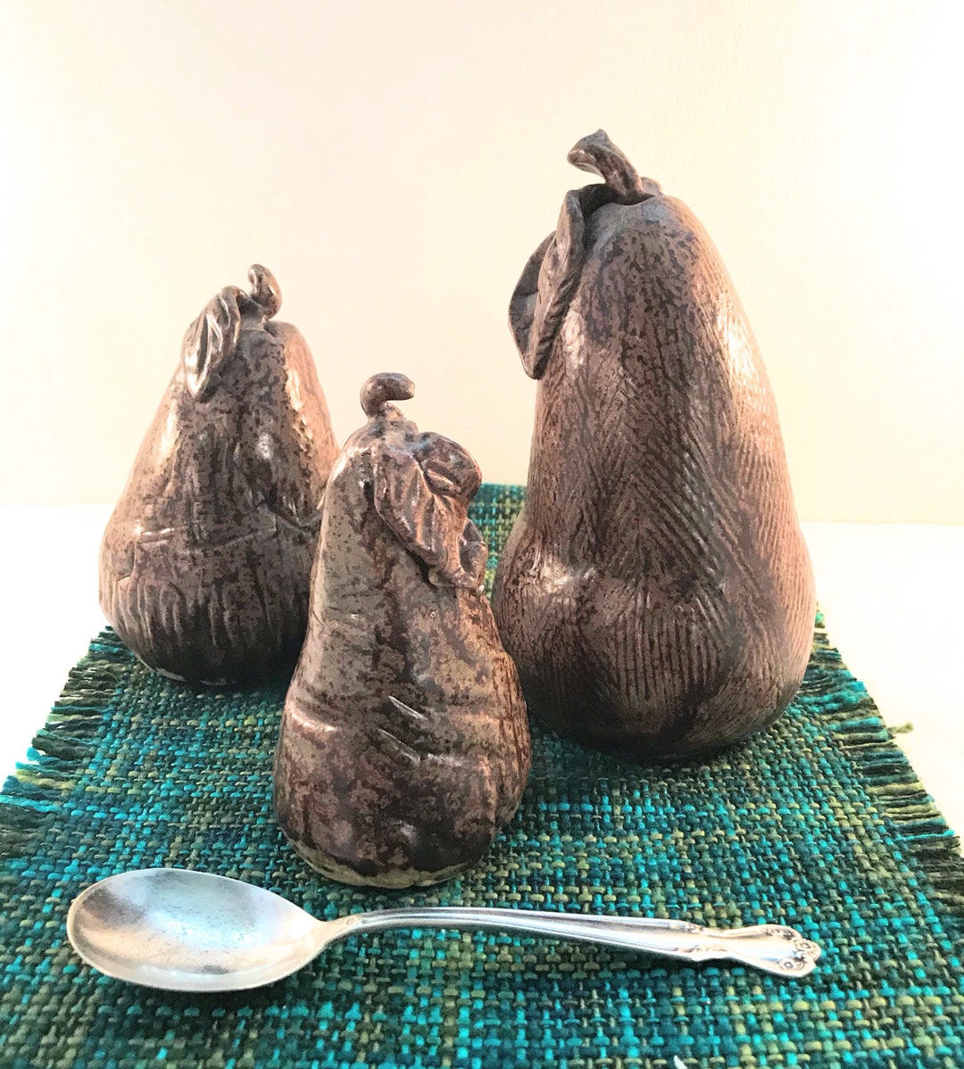 Three sacred pears, sculpted in red clay. Glazed in brown. Often the ...