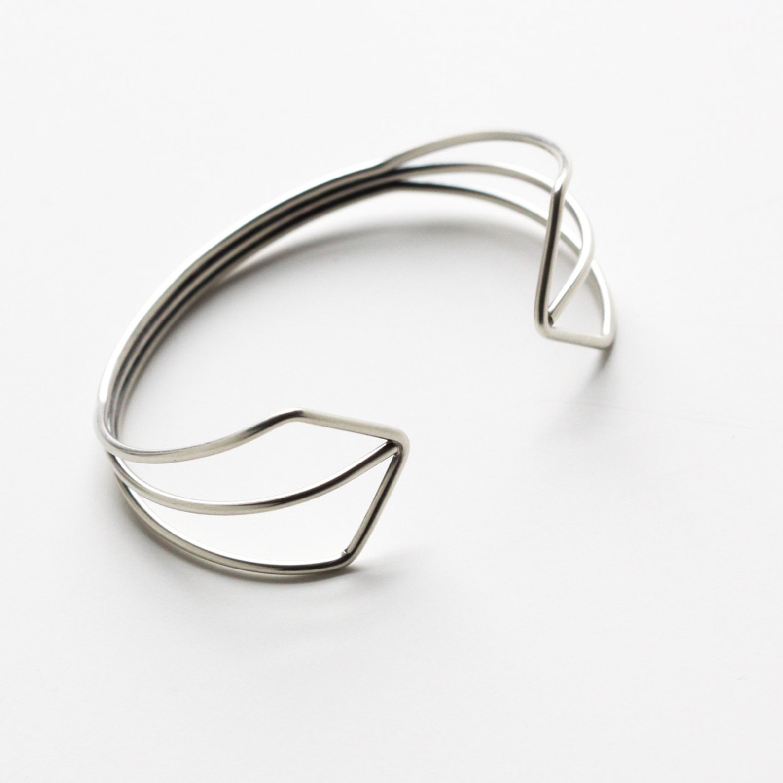 Geometric bracelet designed with angles and lines its open | Etsy