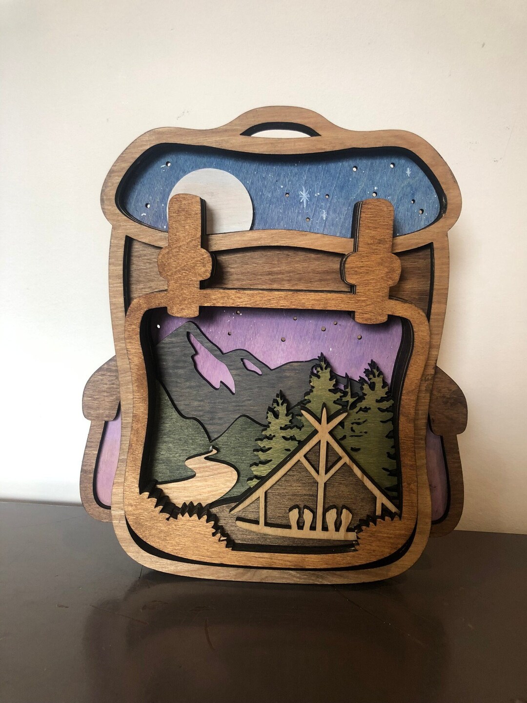 3D Stained Wood Backpack Scene With Trees, Mountain and Camping Nested ...
