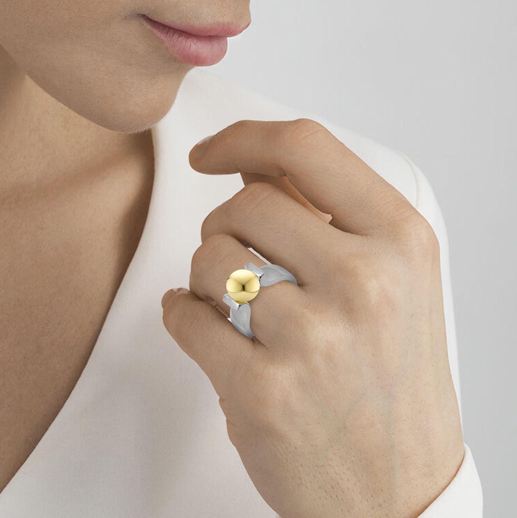 Lyre shaped ring with tension set Gold sphere in stainless steel by ...