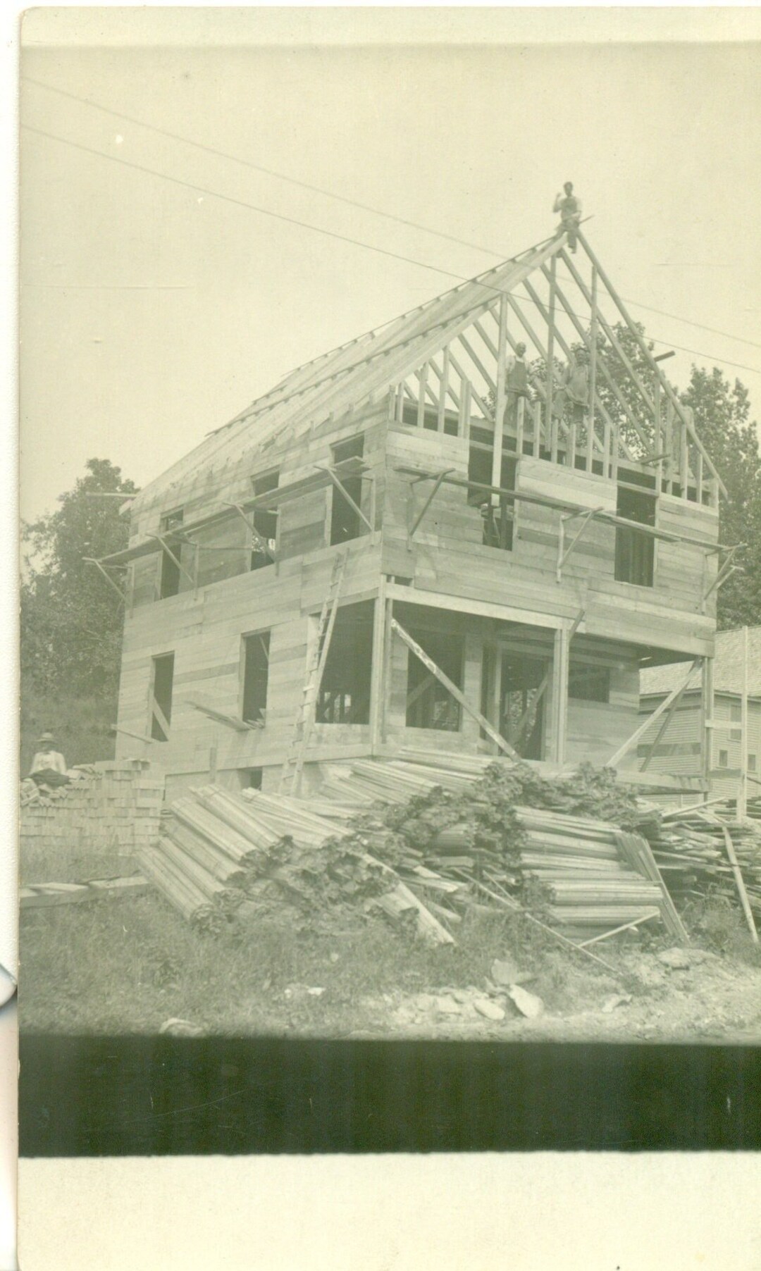 Under Construction Workers Man Sitting on Top of Framed House Roof ...